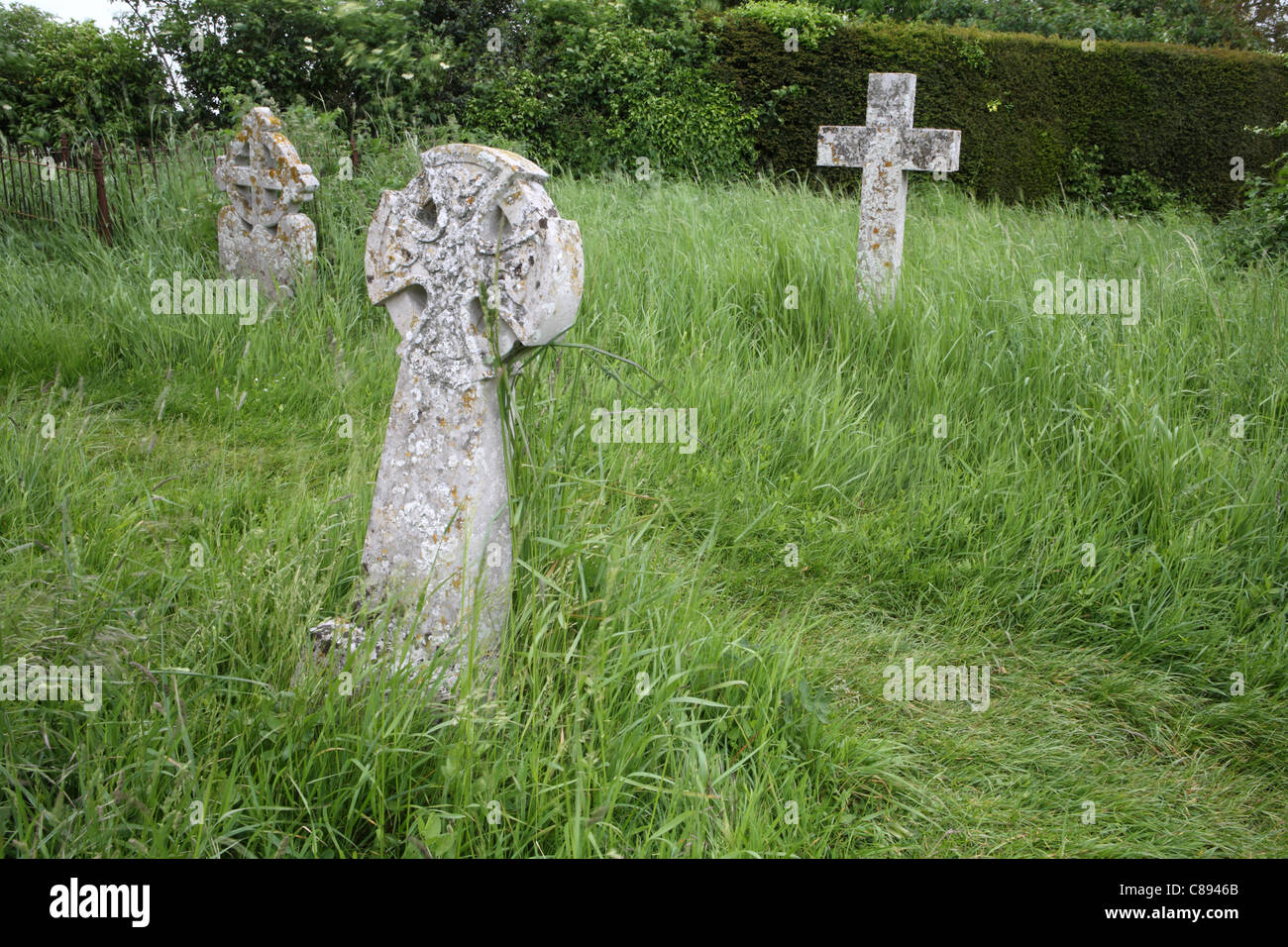 Graves in overgrown church cemetery Stock Photo - Alamy