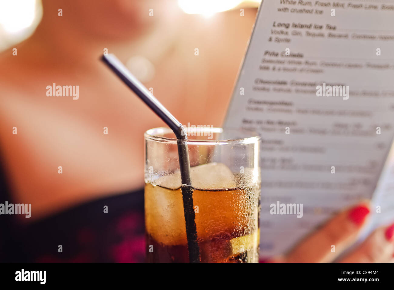 enjoying a coke whilst reading a menu Stock Photo - Alamy