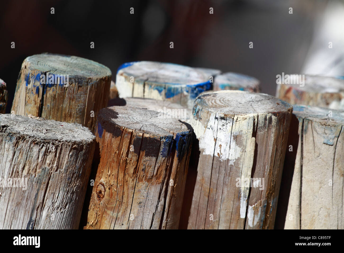 Paint stained wooden logs Stock Photo - Alamy