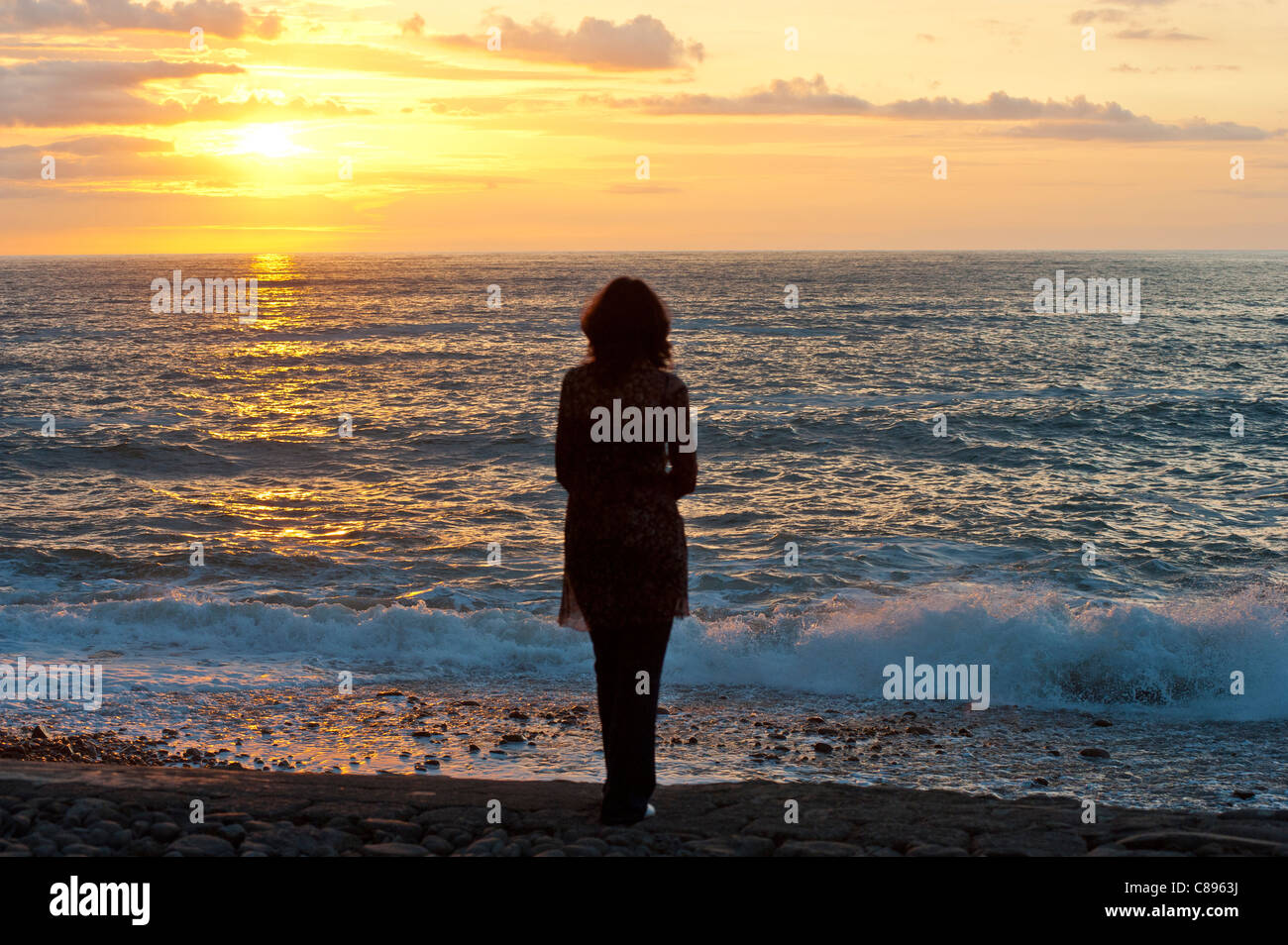 Women on the beach at sunset Stock Photo - Alamy