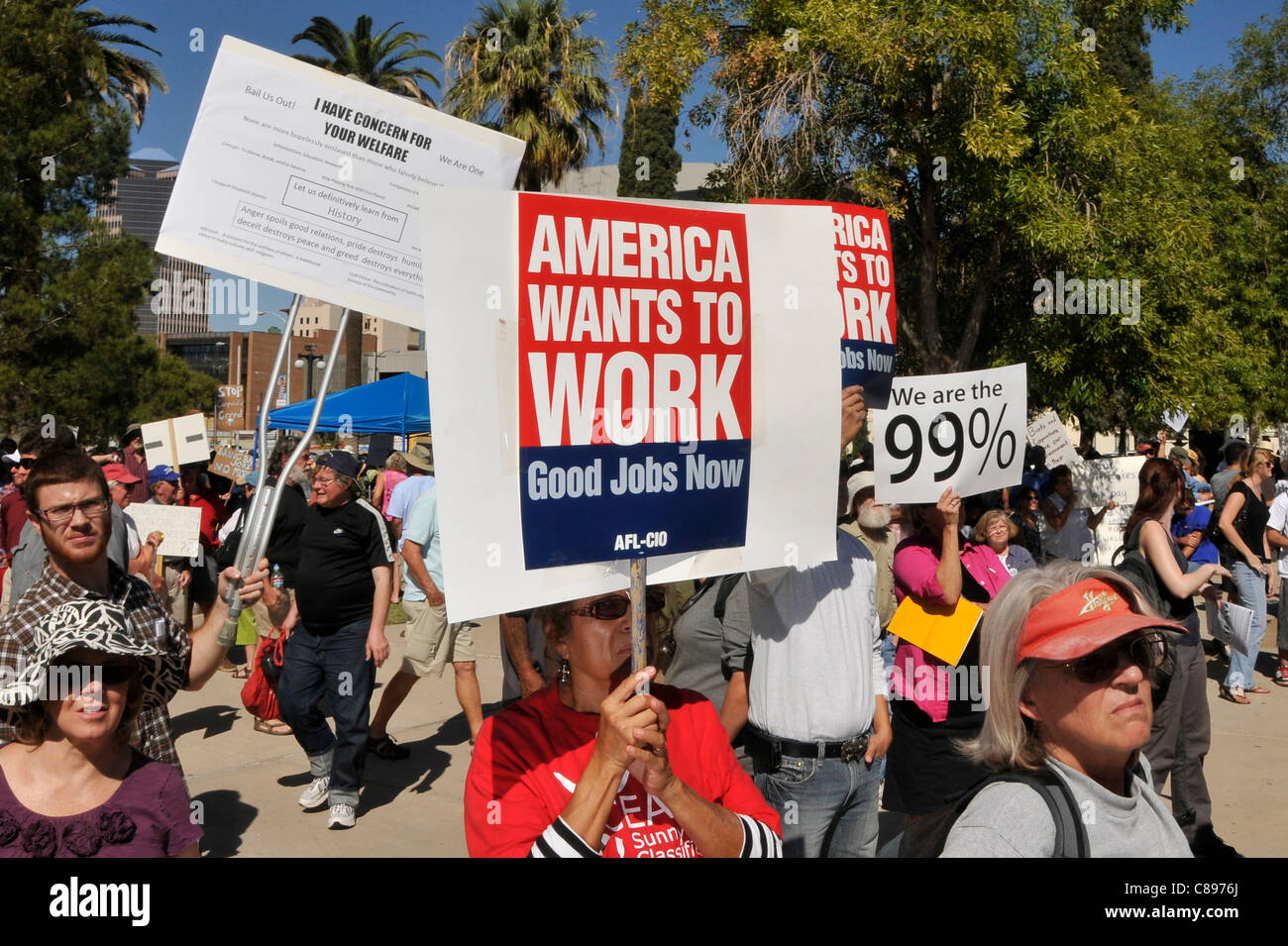 Dominga Sierra (holding sign) protests, along with about 1,000 ...