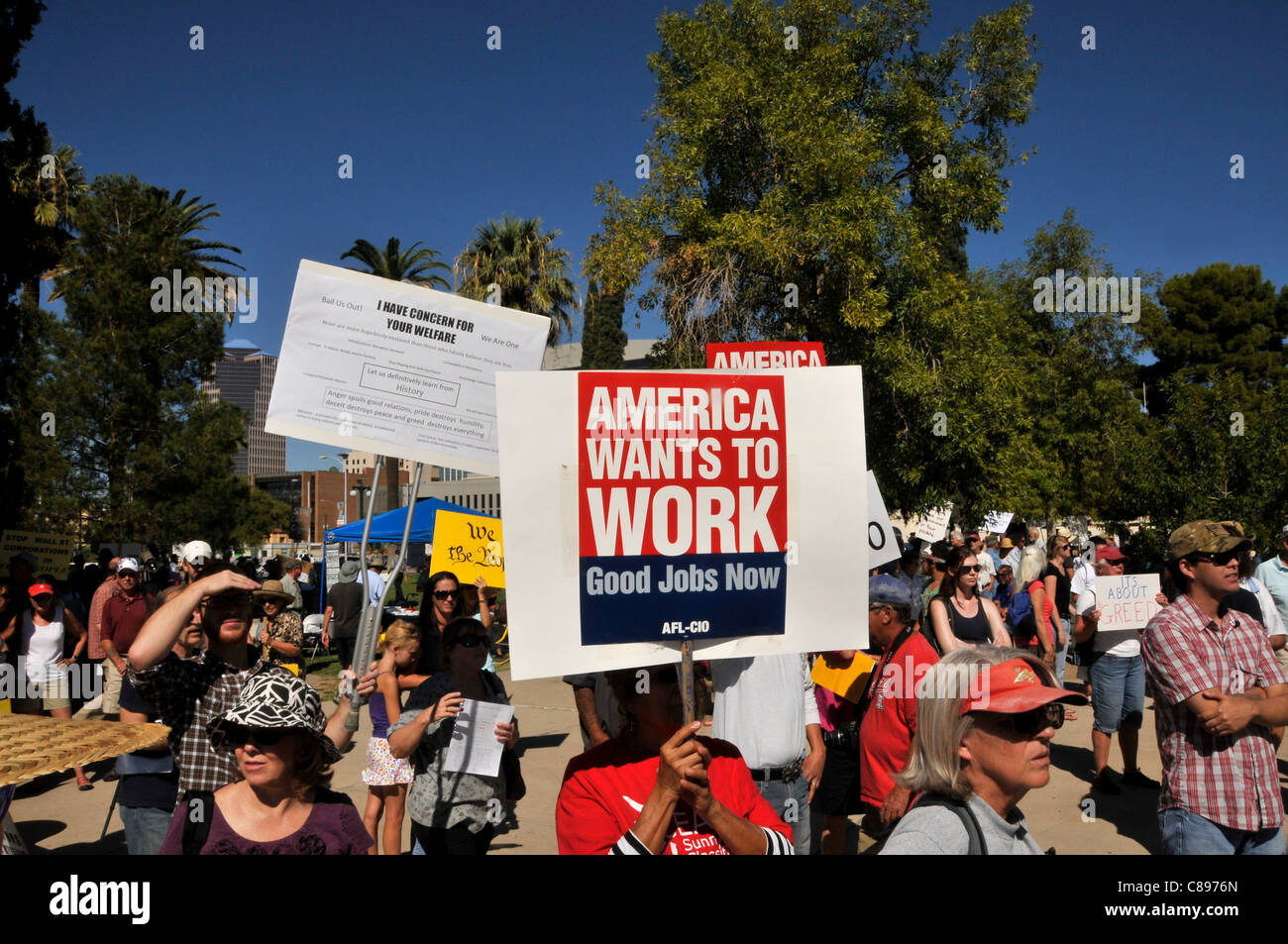 Dominga Sierra (holding sign) protests, along with about 1,000 ...