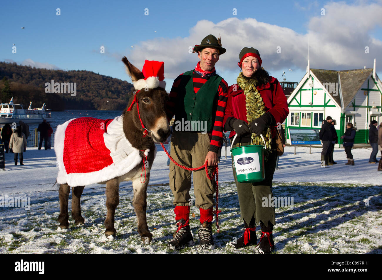 Christmas elves and donkey on Bowness Bay front in the sun & snow Stock ...