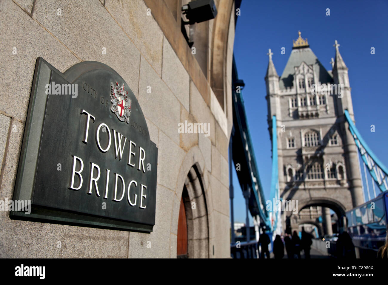 The Tower Bridge sign and one of the towers of the bridge slightly ...