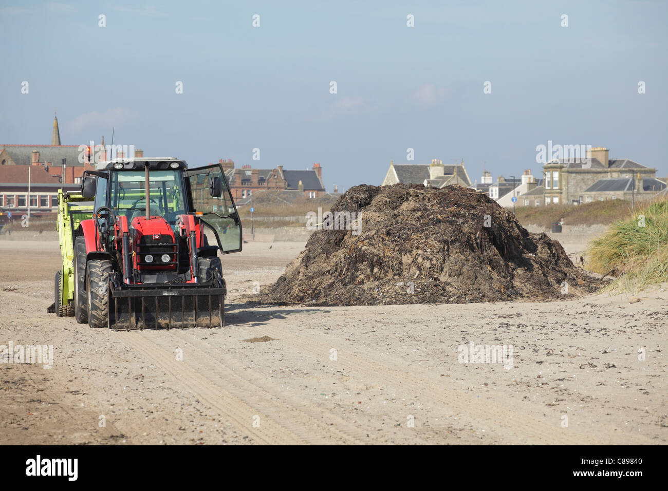 Debris being cleared with a tractor on South Beach in the seaside town ...