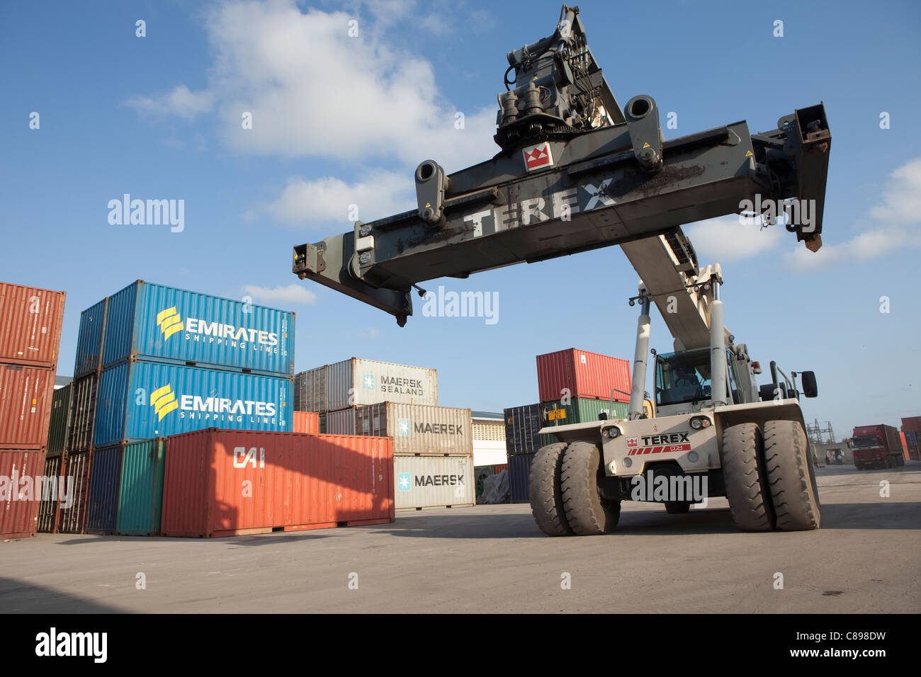 A reach stacker machine is used for moving containers outside a ...
