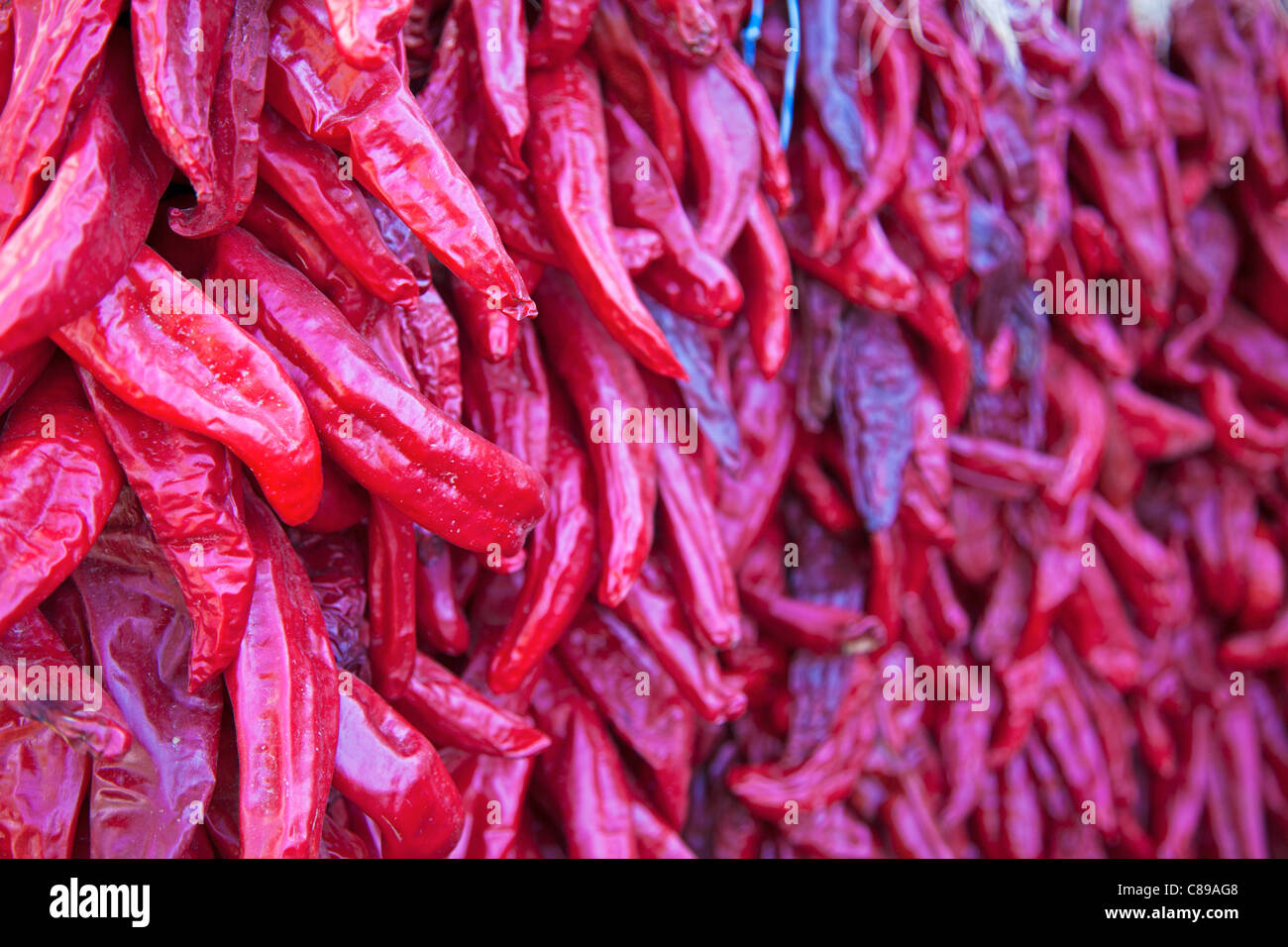 Red hot peppers hanging on the wall Stock Photo - Alamy