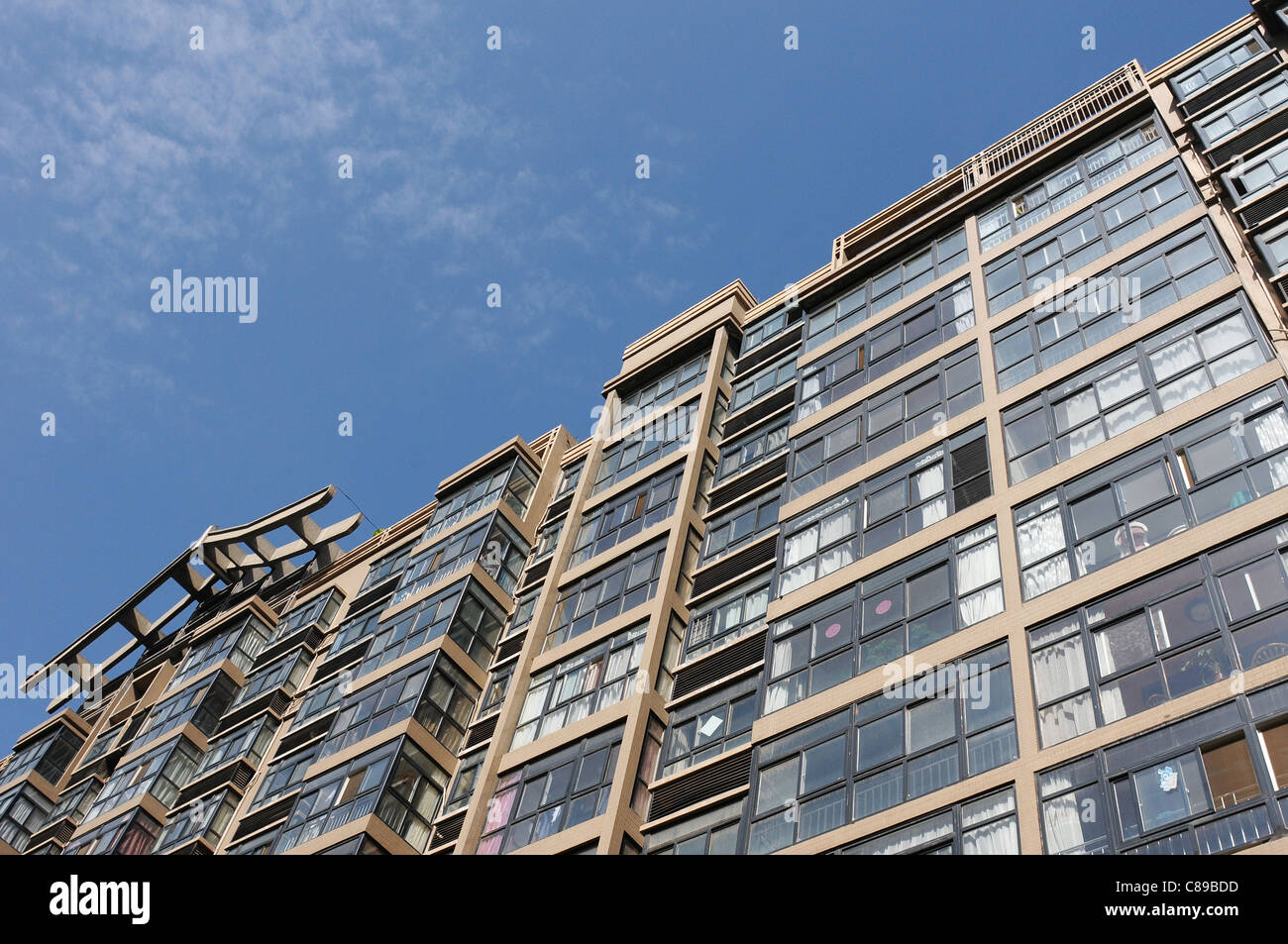 Bottom view of an apartment building against blue sky Stock Photo - Alamy