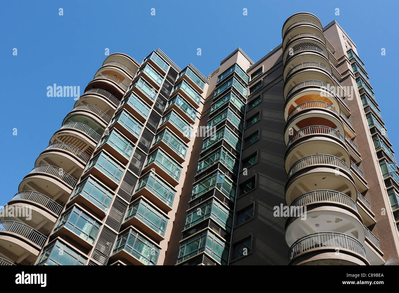 Bottom view of an apartment building against blue sky Stock Photo - Alamy