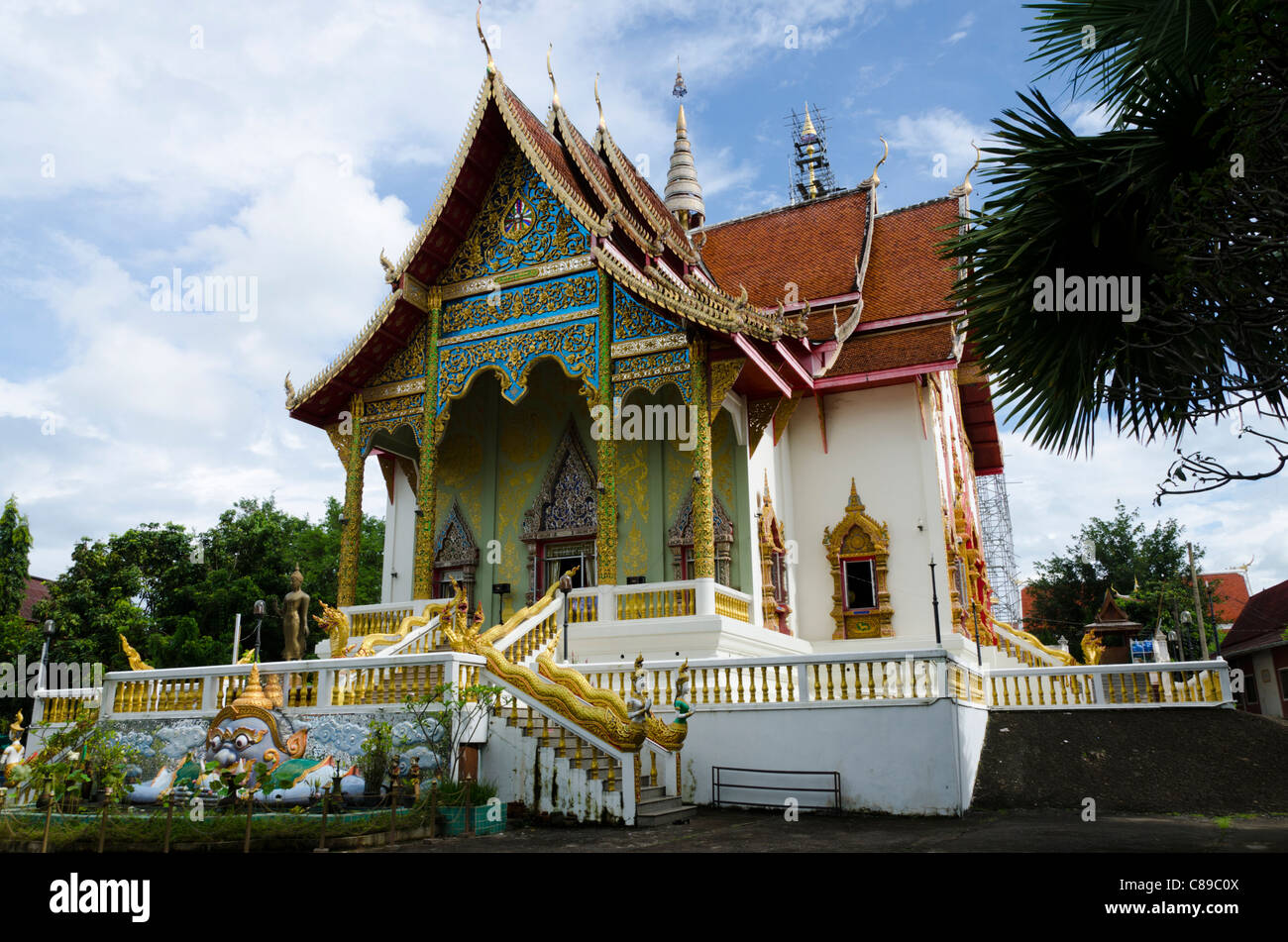 A Buddhist Thai temple sermon hall glistens in sunshine at Wat Doi ...