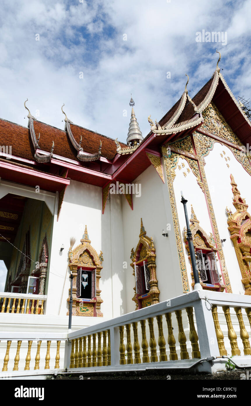 A Buddhist Thai temple sermon hall glistens in sunshine at Wat Doi ...
