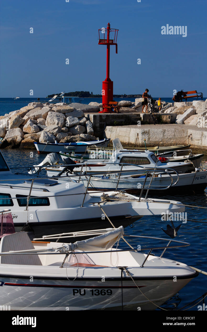 Anchored boats and the lighthouse with visitors Stock Photo - Alamy