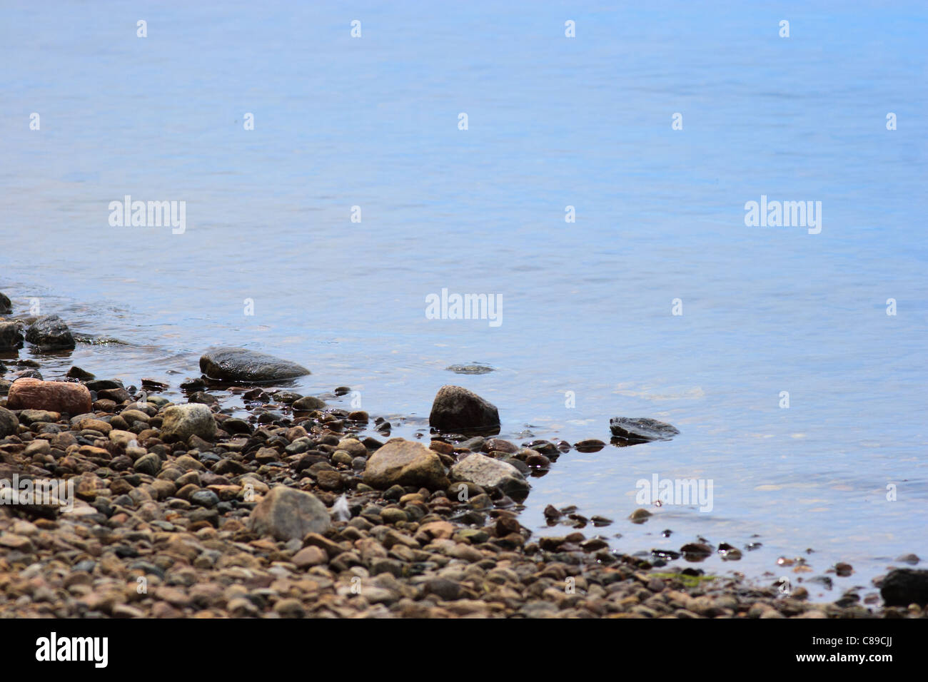 Close Up of Water Lapping Over Pebbles on the Beach Stock Photo - Alamy