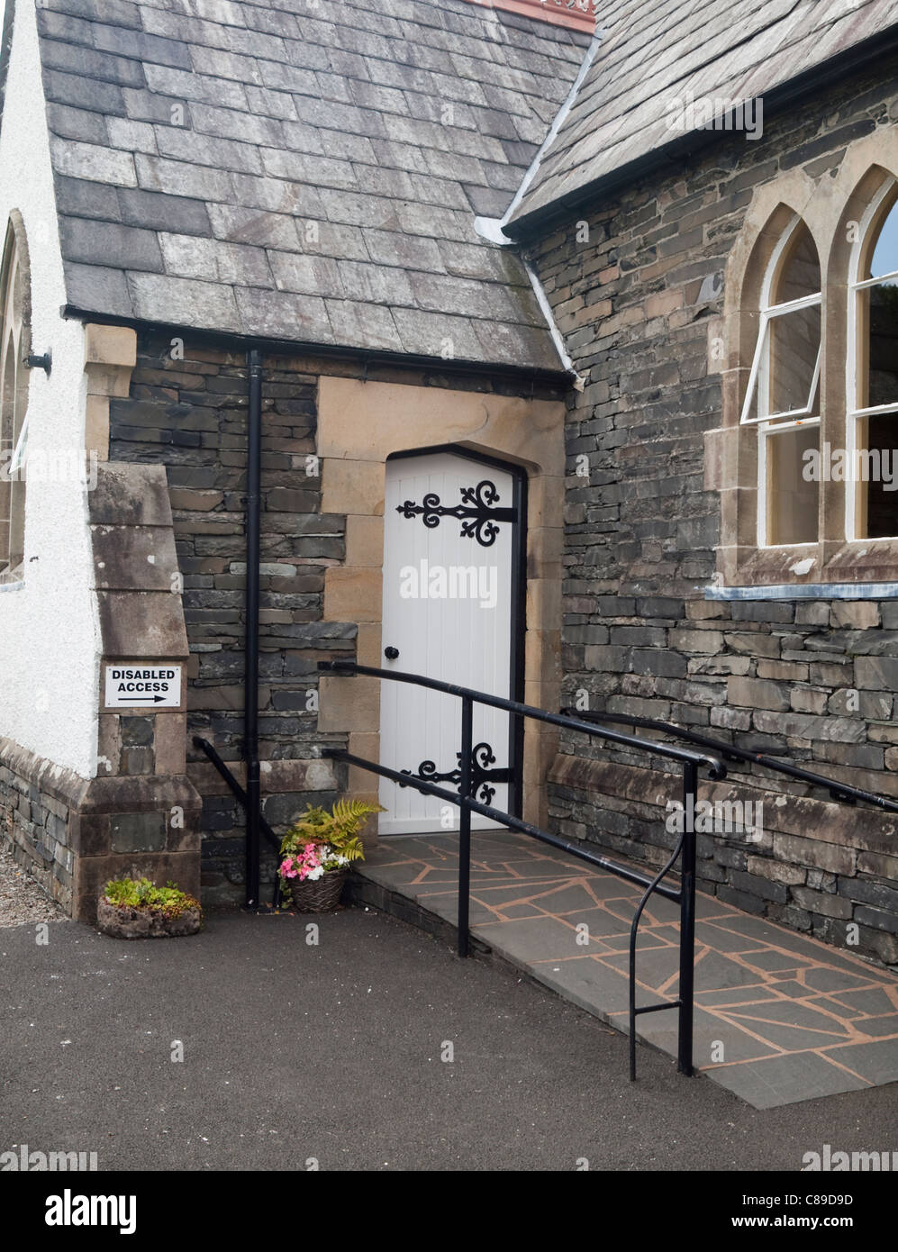 Side entrance with wheelchair access ramp. Architectural detail of the ...