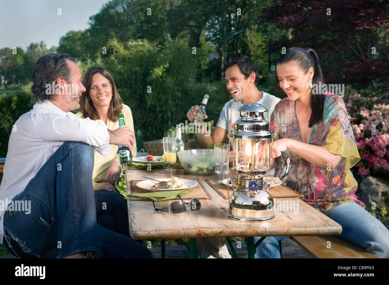 Germany, Bavaria, Friends enjoying barbecue food and drinks Stock Photo ...