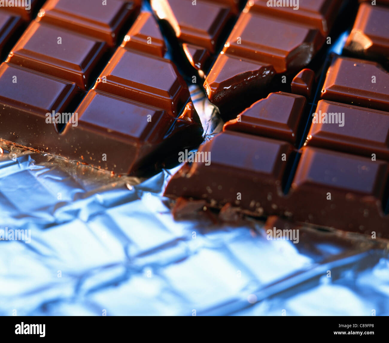 Broken bar of dark chocolate Stock Photo - Alamy