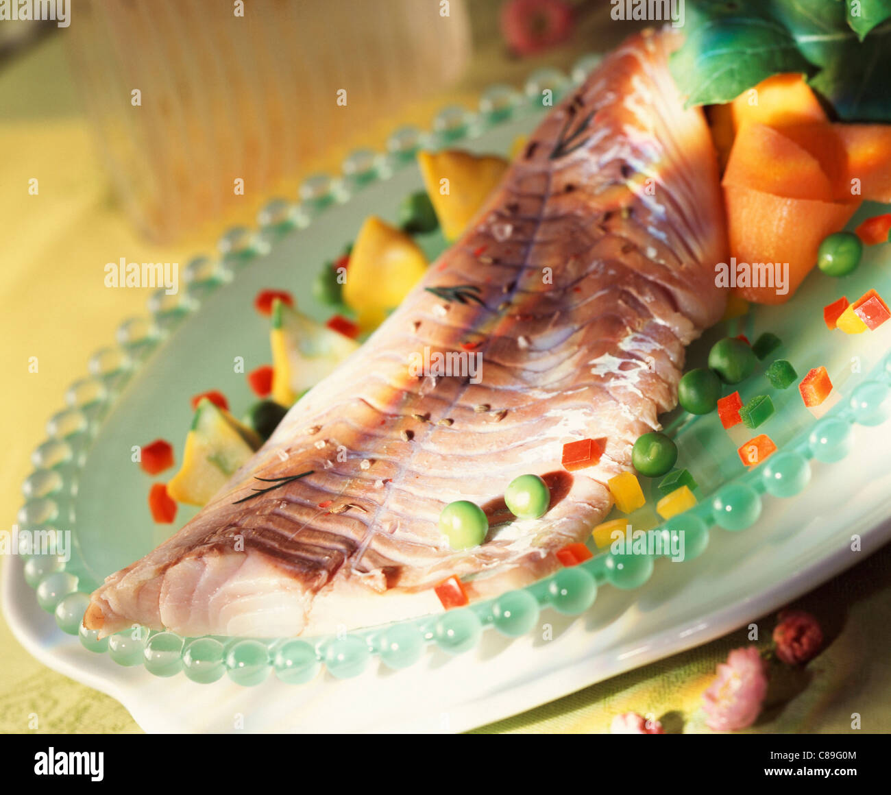 Fillet of cod with baby vegetables Stock Photo - Alamy