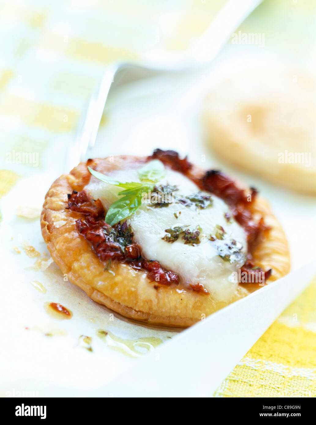 Mini flaky pastry tart with tomato Stock Photo - Alamy