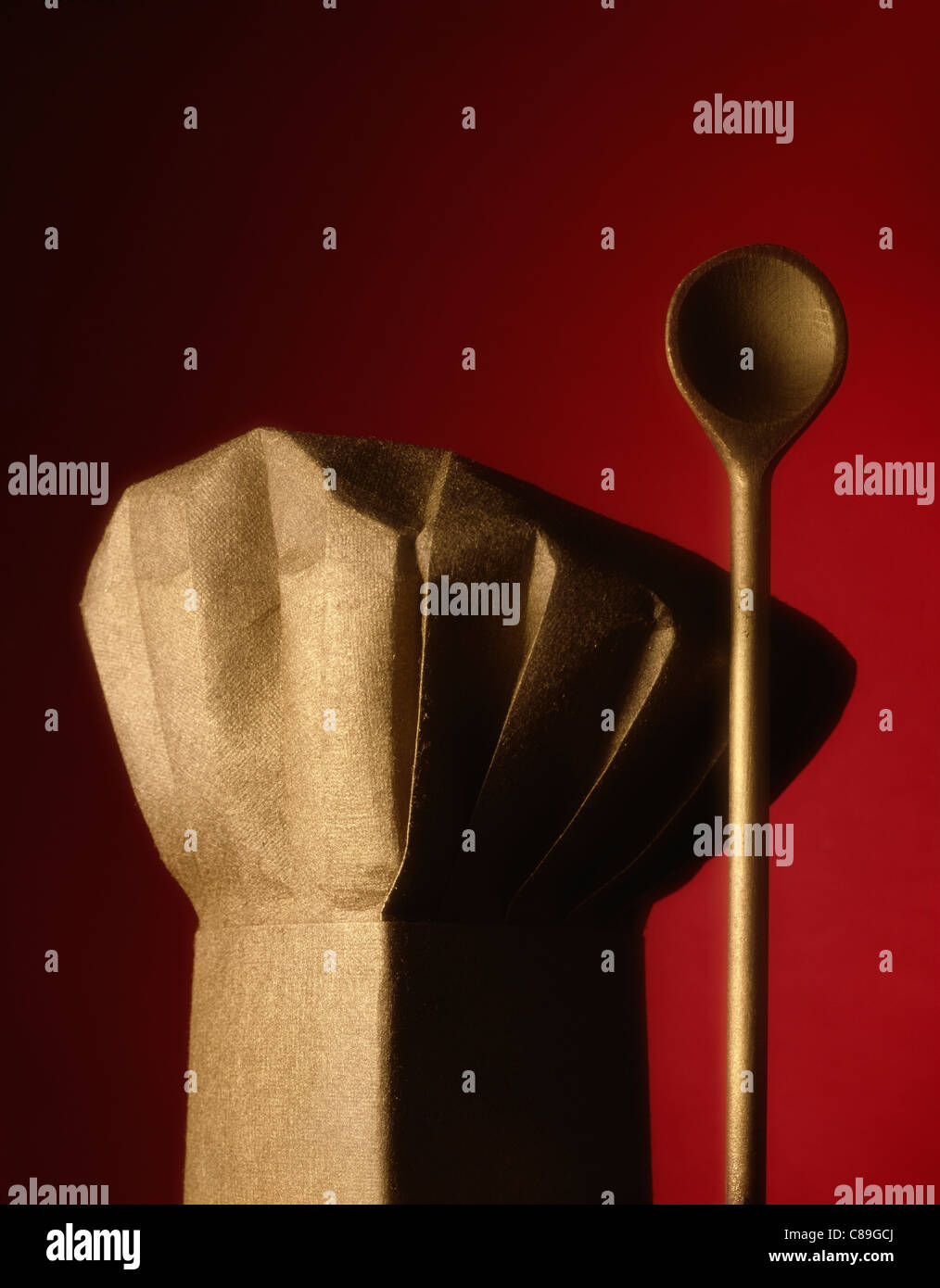 Chef's hat and golden spoon Stock Photo - Alamy