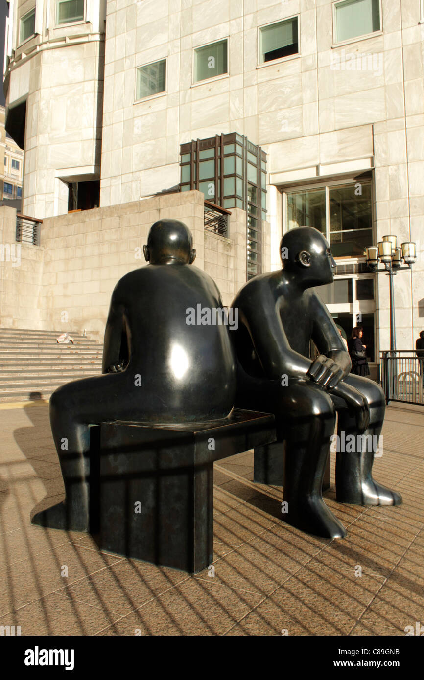Statues of people sitting on bench Canary Wharf Docklands London Stock ...
