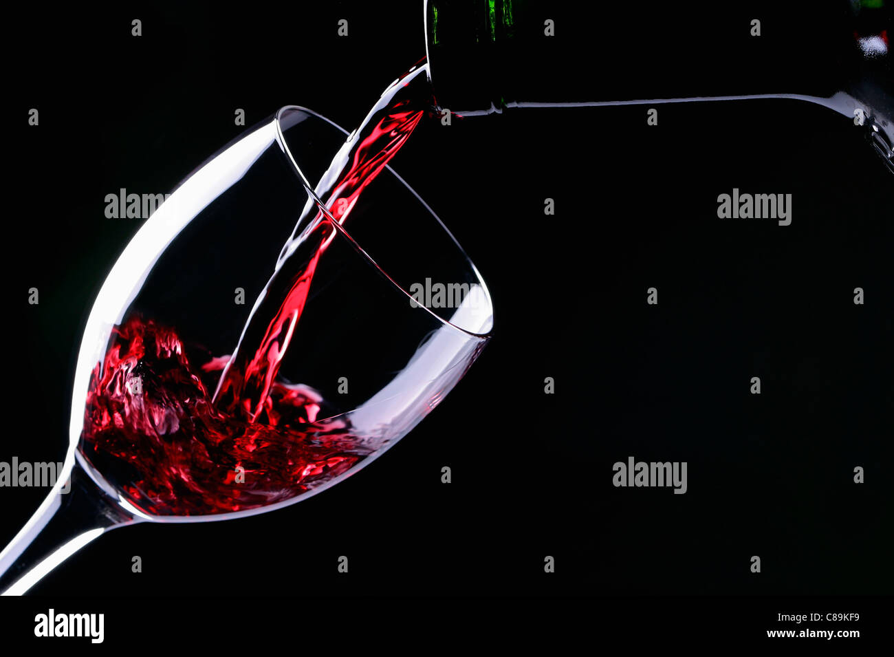 Pouring red wine into glass Stock Photo - Alamy
