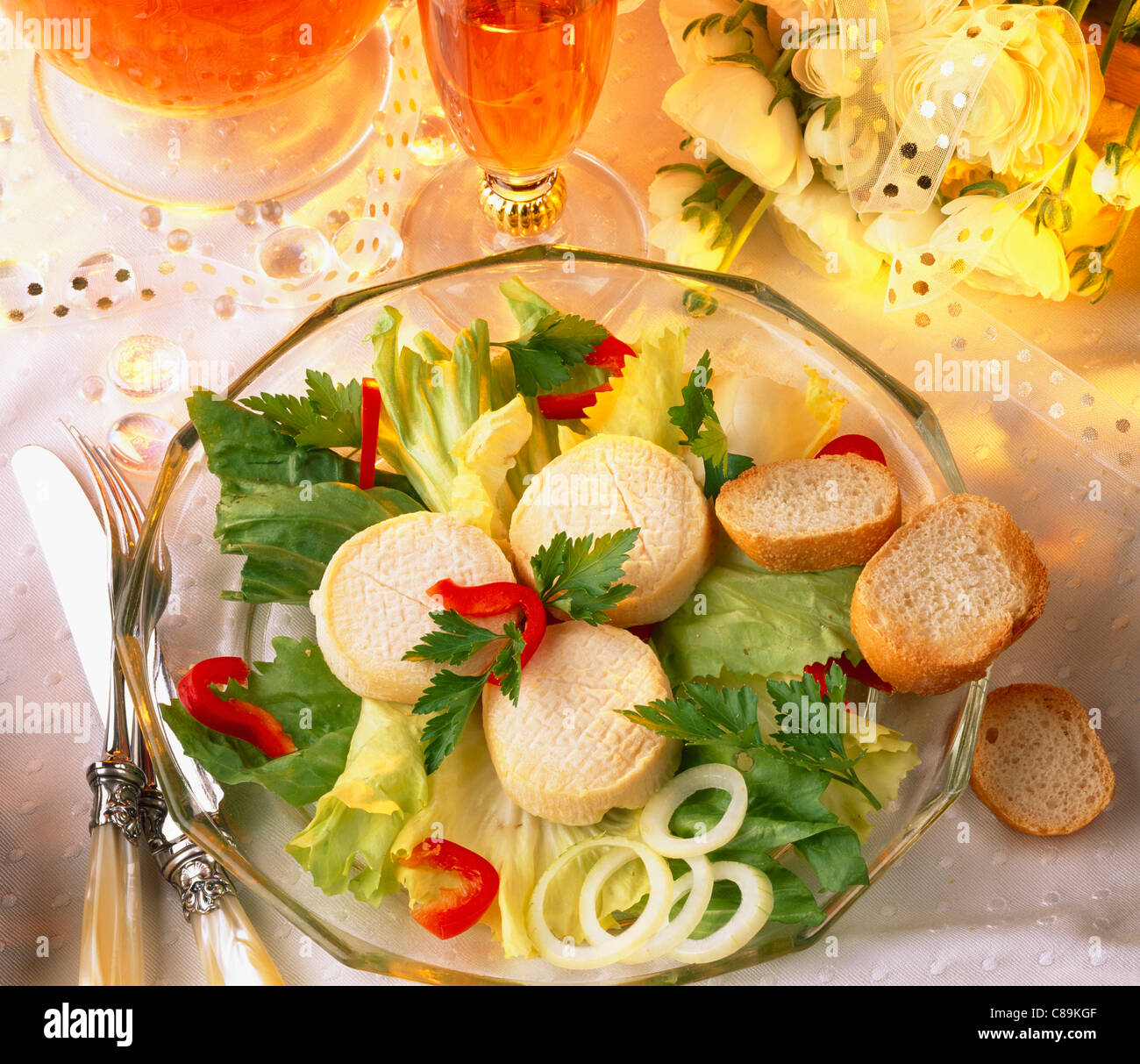 Goat's cheese on bed of lettuce Stock Photo - Alamy