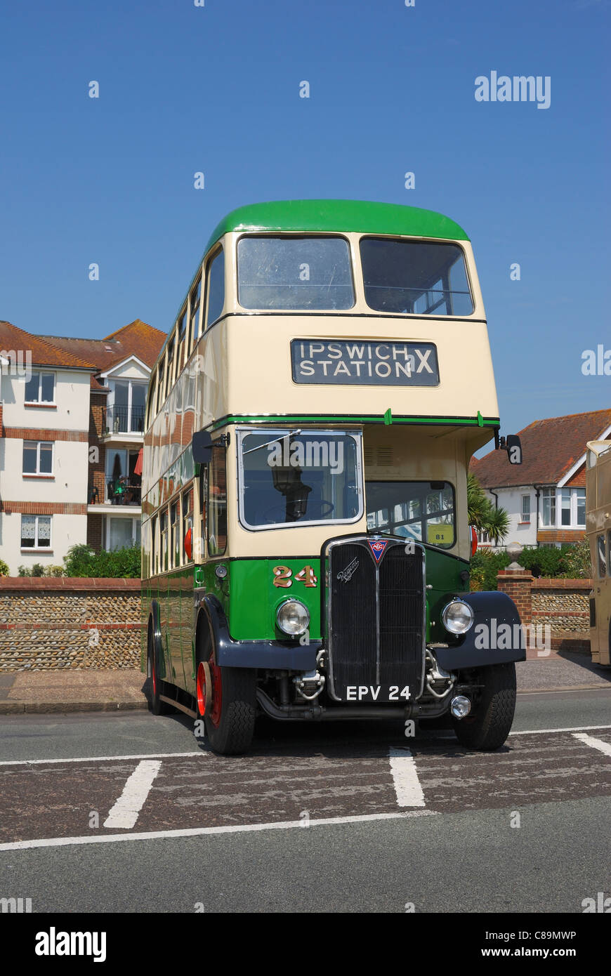 Classic English green and cream double decker bus at seafront fair and ...