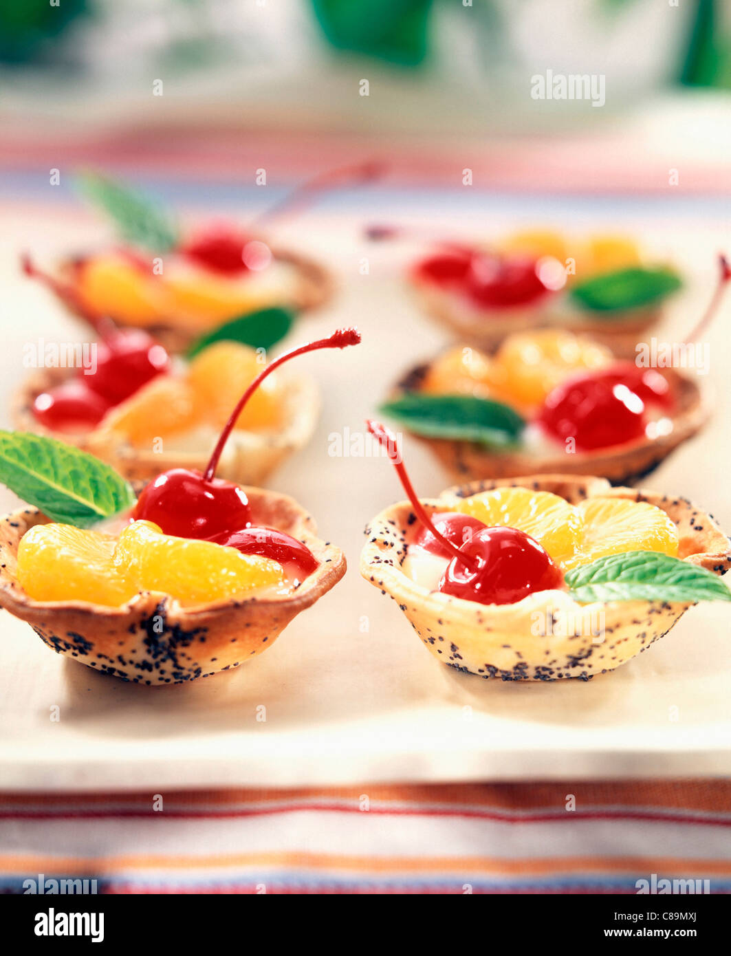 Individual cherry and clementine tarts Stock Photo - Alamy