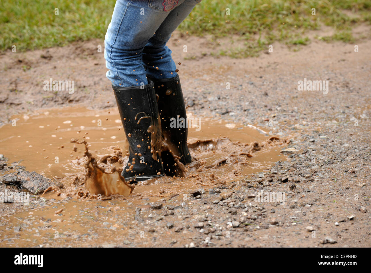 Child playing in puddle Stock Photo - Alamy