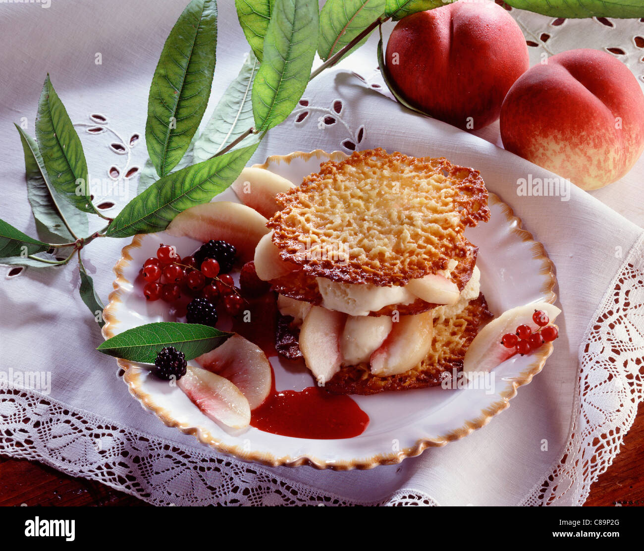 Layered peach and Feuillantine biscuit dessert Stock Photo - Alamy