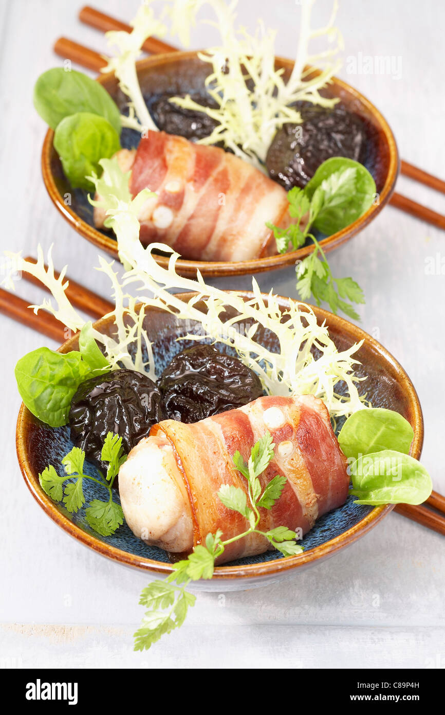 Rabbit wrapped in bacon with prunes Stock Photo - Alamy