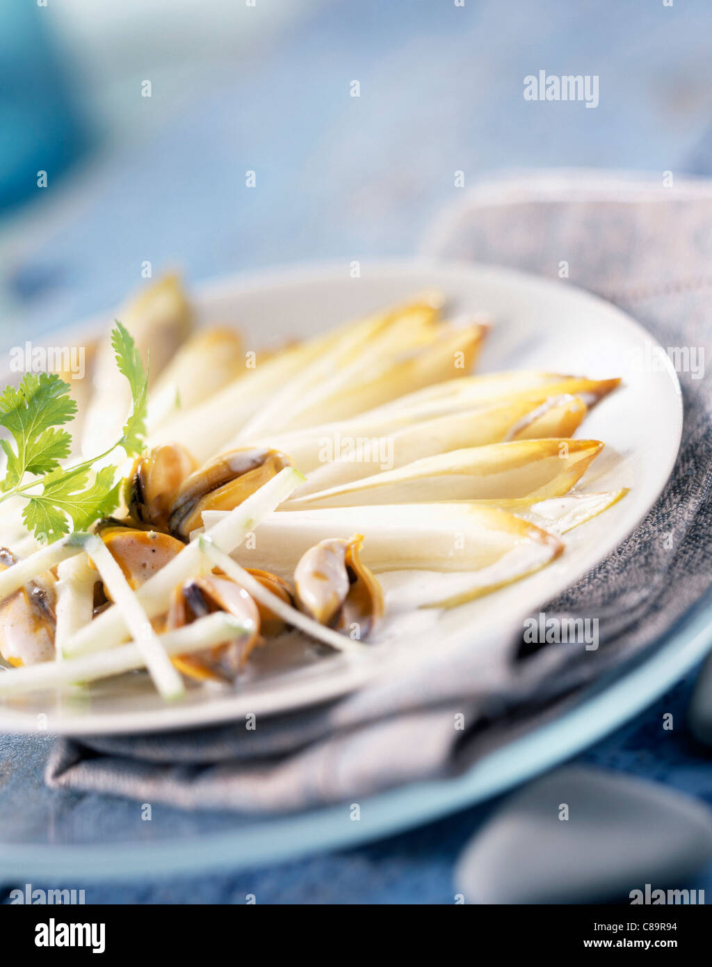 Mussels with apples, chicory and cream Stock Photo - Alamy