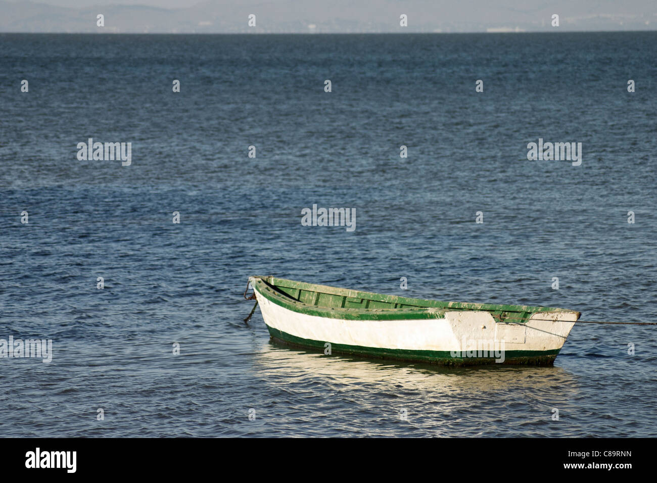 empty row boat anchored in bay Stock Photo - Alamy