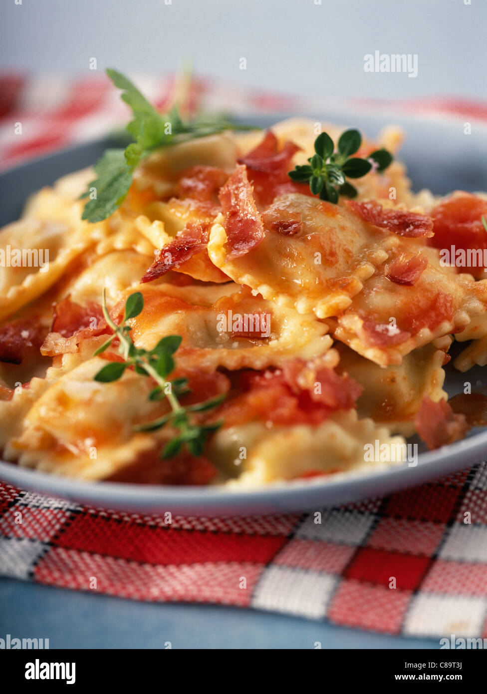 Raviolis with raw ham and tomato sauce Stock Photo - Alamy