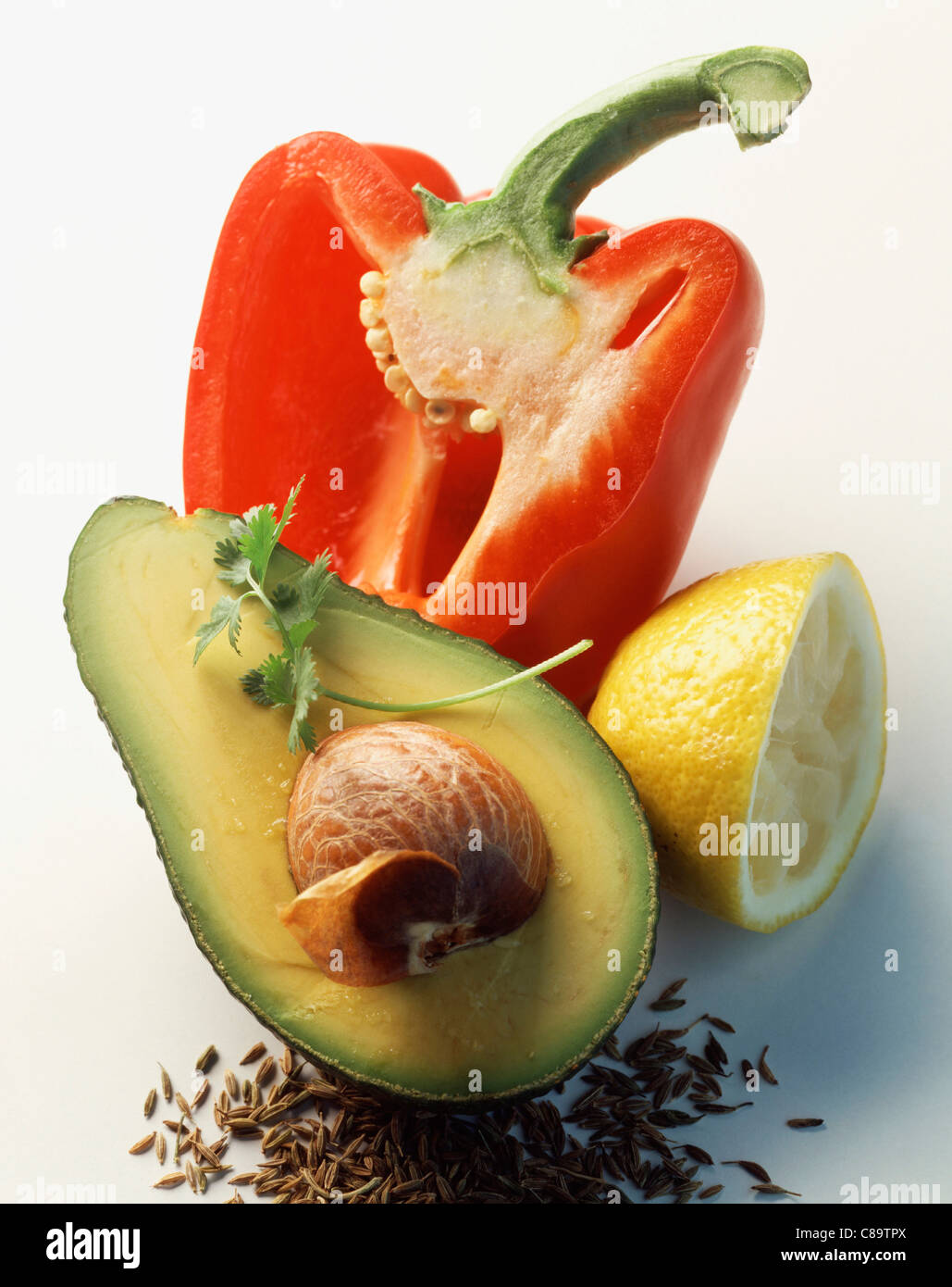 Halved avocado, red pepper and lemon Stock Photo - Alamy