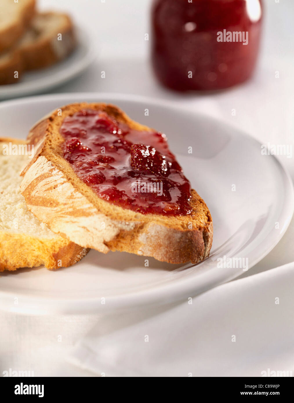 Slice of bread with strawberry jam Stock Photo - Alamy