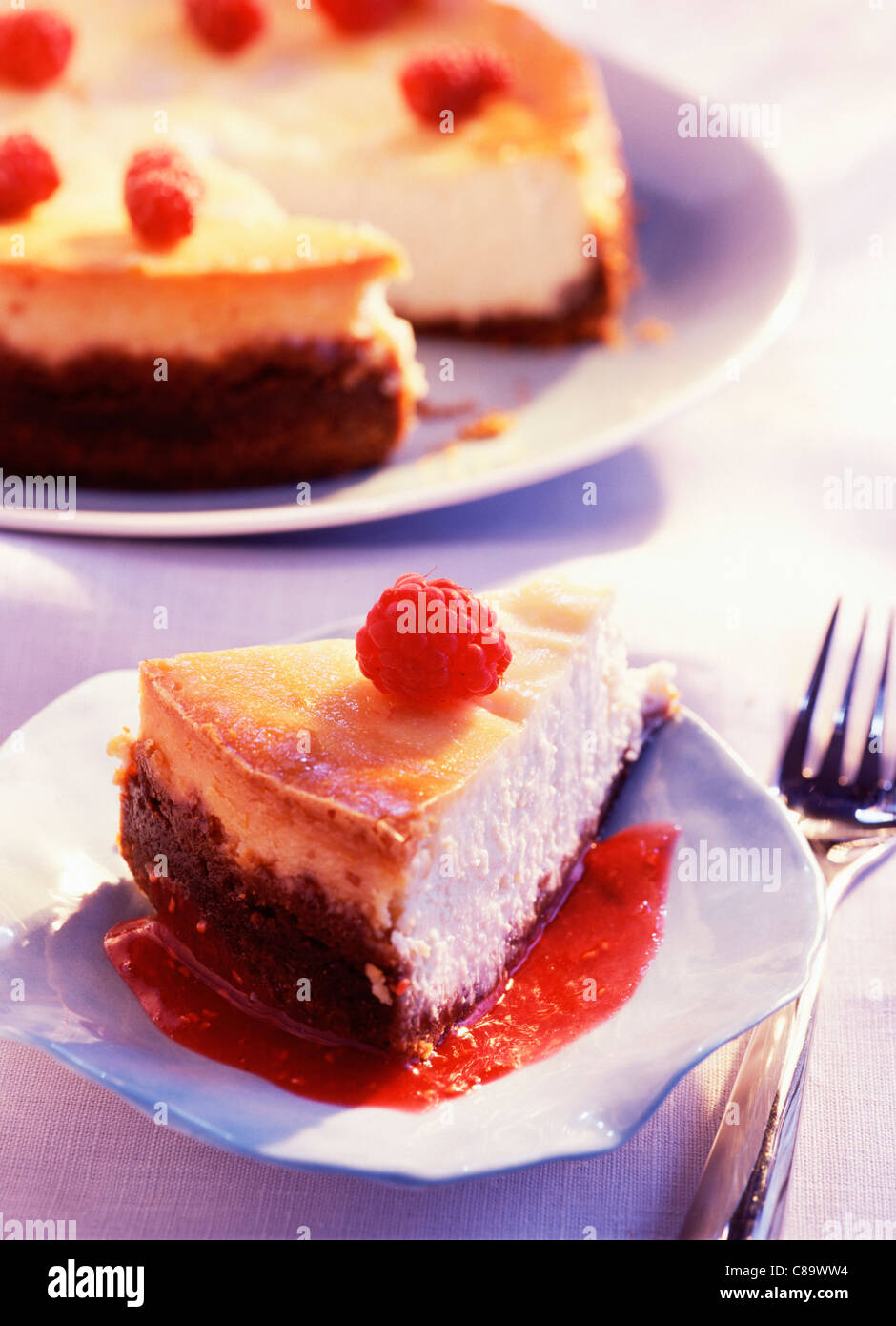 Cheesecake with raspberry sauce Stock Photo - Alamy