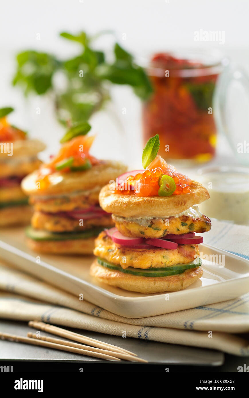 Salmon and mixed herb mini burgers Stock Photo - Alamy