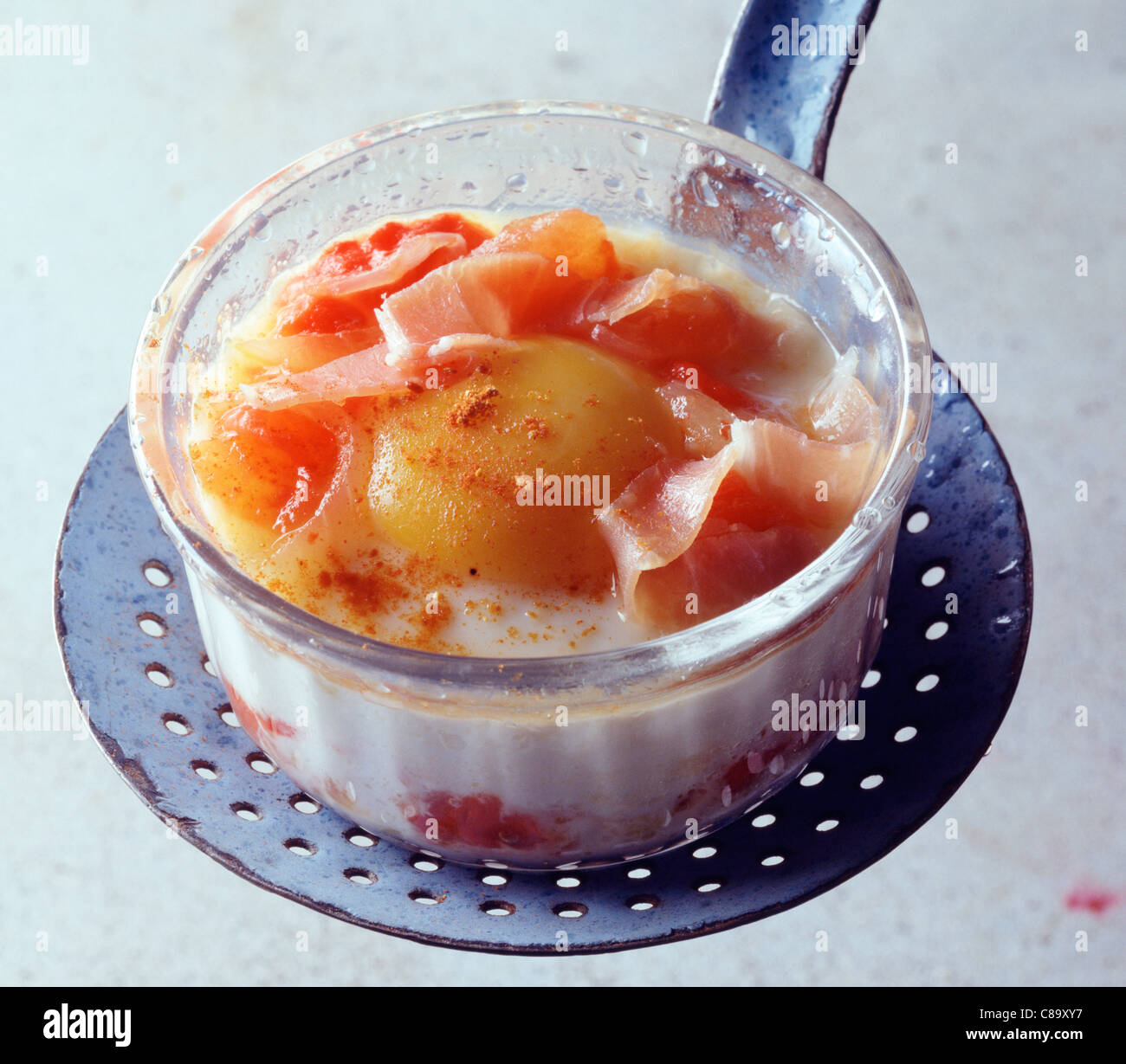 Coddled eggs with ham piperade Stock Photo - Alamy