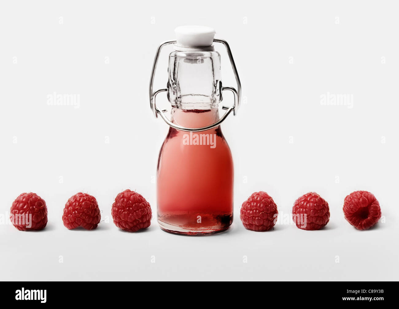 Small bottle of raspberry syrup Stock Photo - Alamy