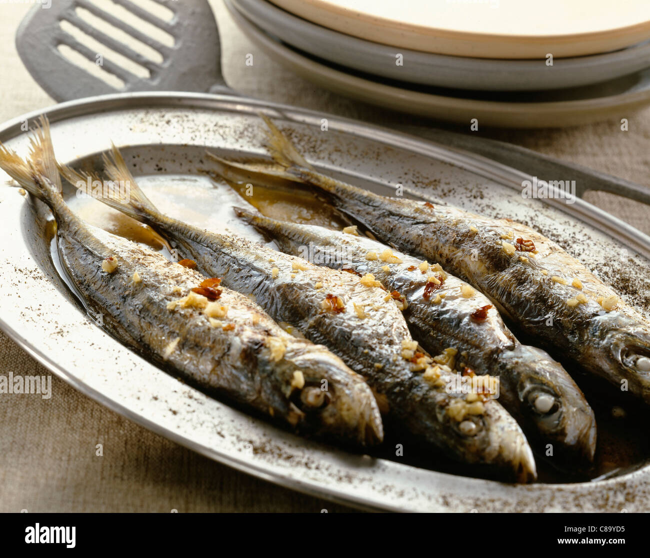 Baked saurel fish on plate Stock Photo - Alamy