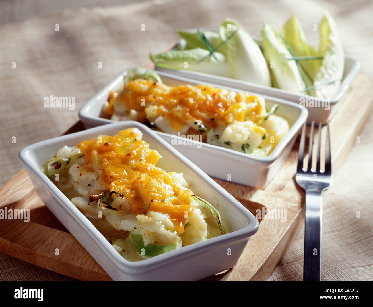 Cod and potato bake topped with grilled Mimolette cheese Stock Photo ...