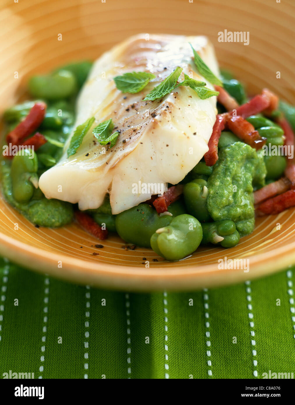 Cod with green sauce and broad beans Stock Photo - Alamy