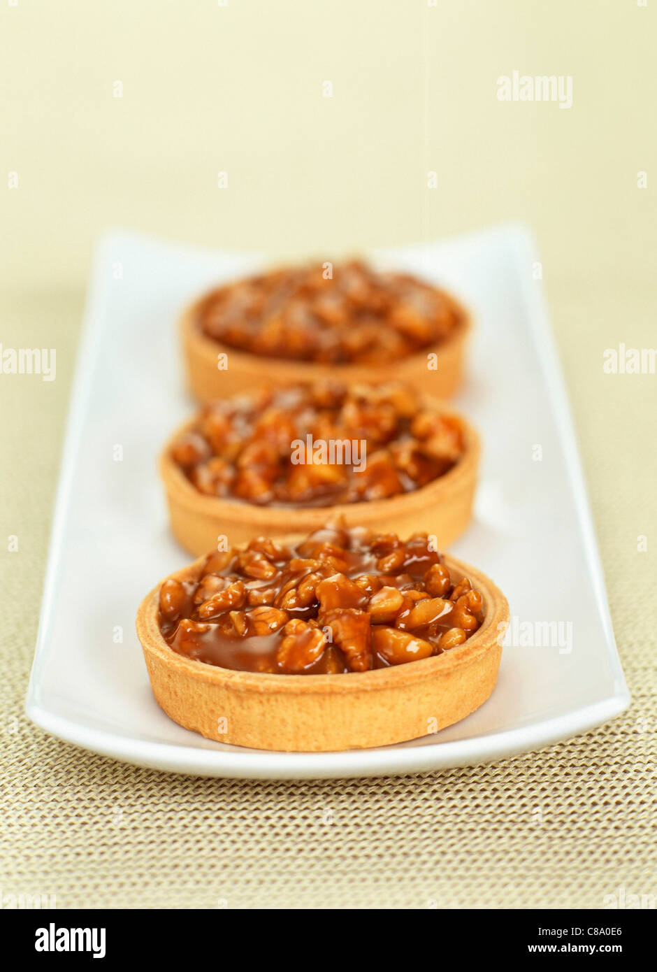 Individual nut and toffee tarts Stock Photo - Alamy