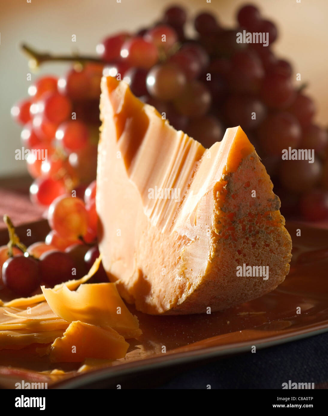 Mature Gouda cheese with grapes Stock Photo - Alamy
