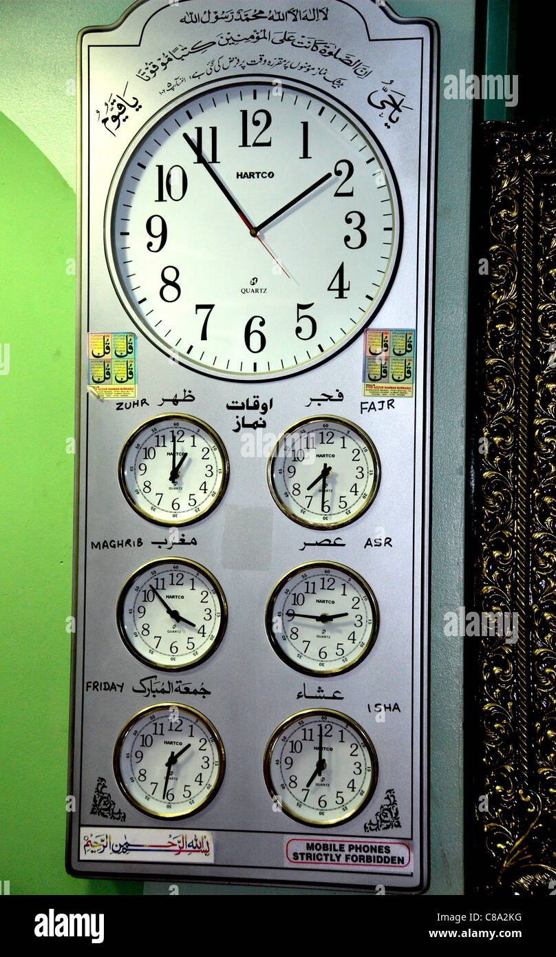 A mosque clock showing the times of the five daily Muslim prayers Stock ...