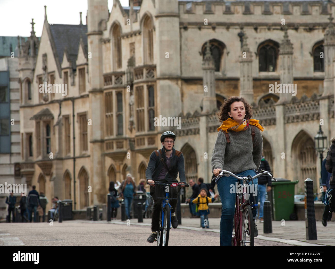 Cambridge University, England. Students cycle past Kings College autumn ...