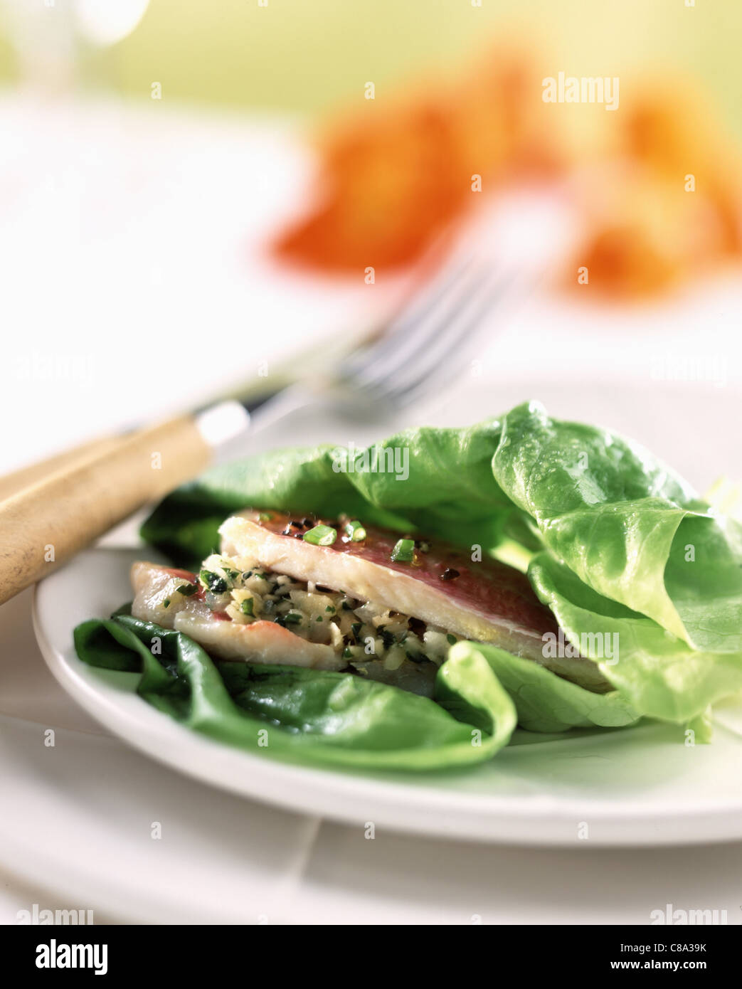 Mullet with lettuce leaves Stock Photo - Alamy