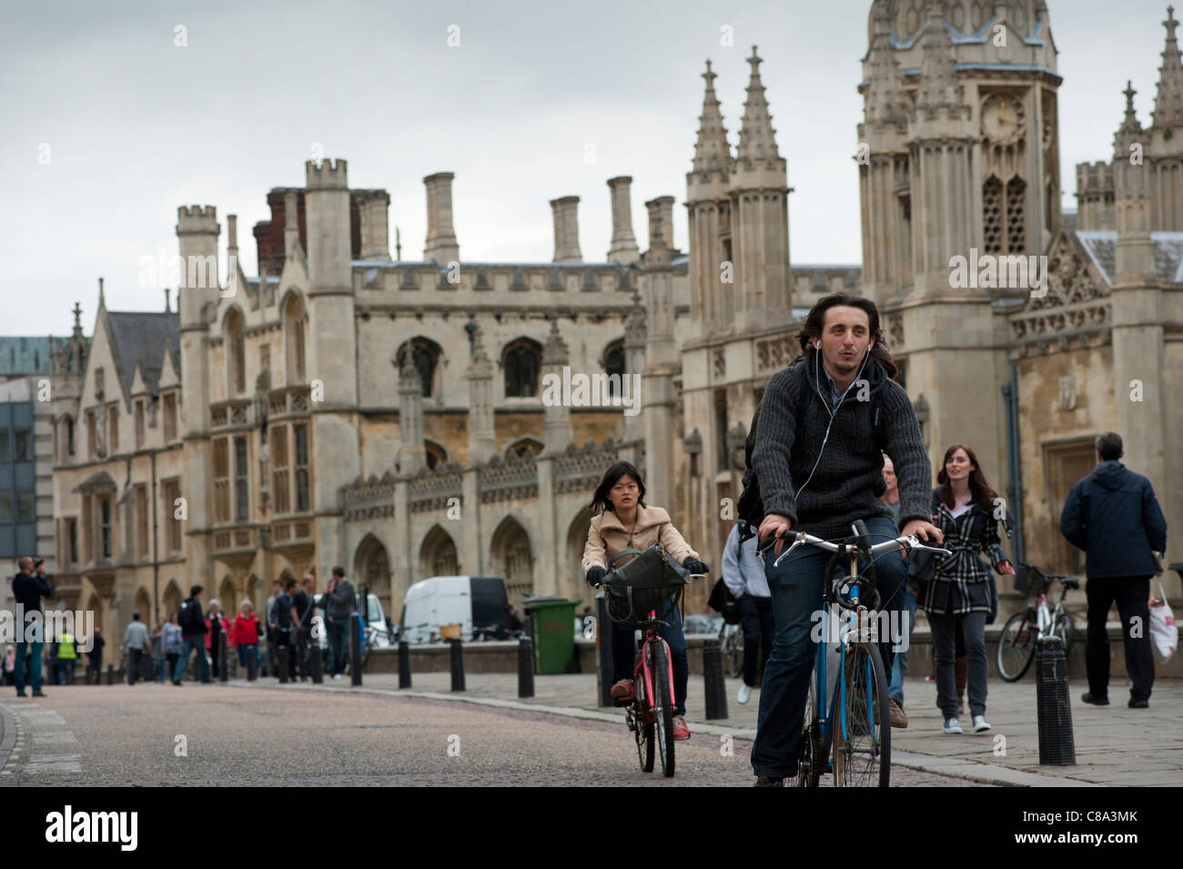 Cambridge University, England. Students cycle past Kings College autumn ...