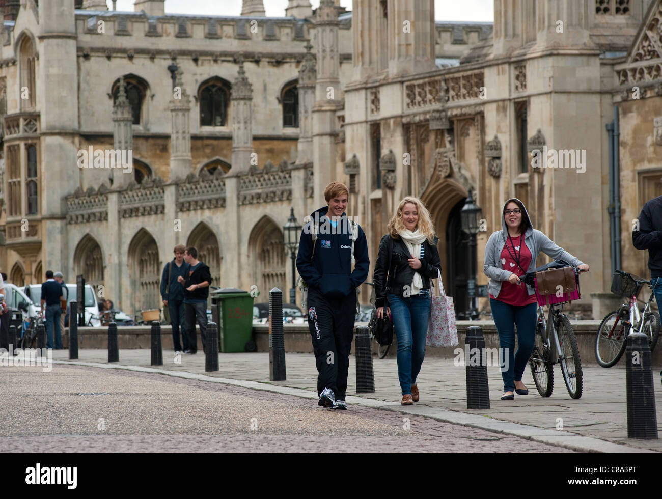 Cambridge University, England. Students cycle past Kings College autumn ...